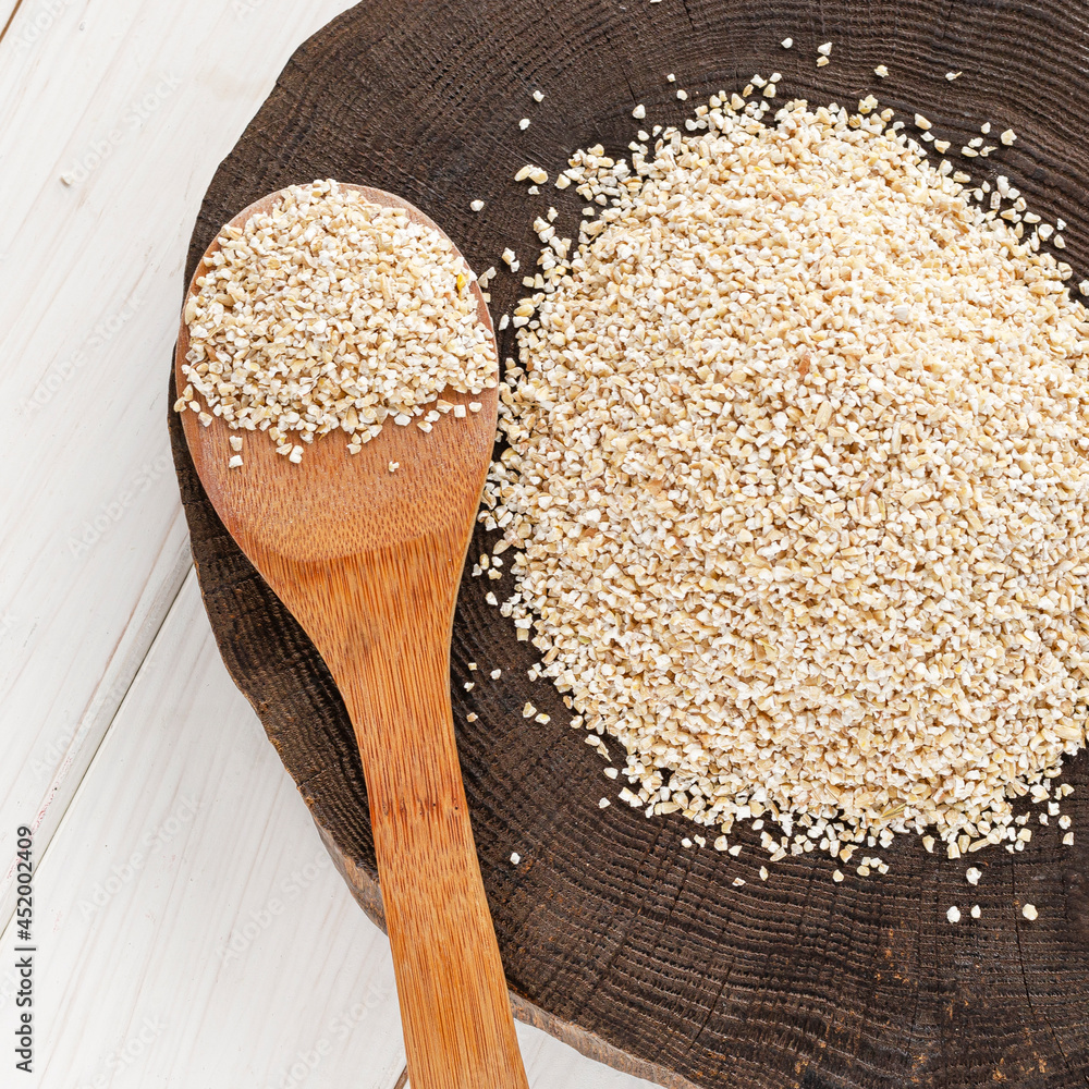 Raw dried broken barley cereal grain texture background macro closeup ...