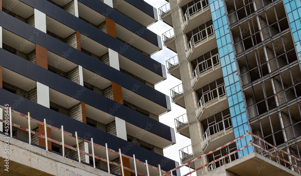 Fragment of the facade of a modern building under construction. Close ...