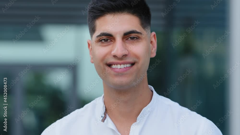 Human male face, smiling Indian guy looks at camera. Motivated ...