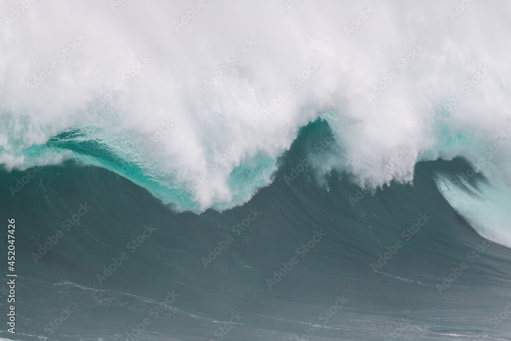 An angry turquoise green colour massive rip curl of a wave as it rolls ...