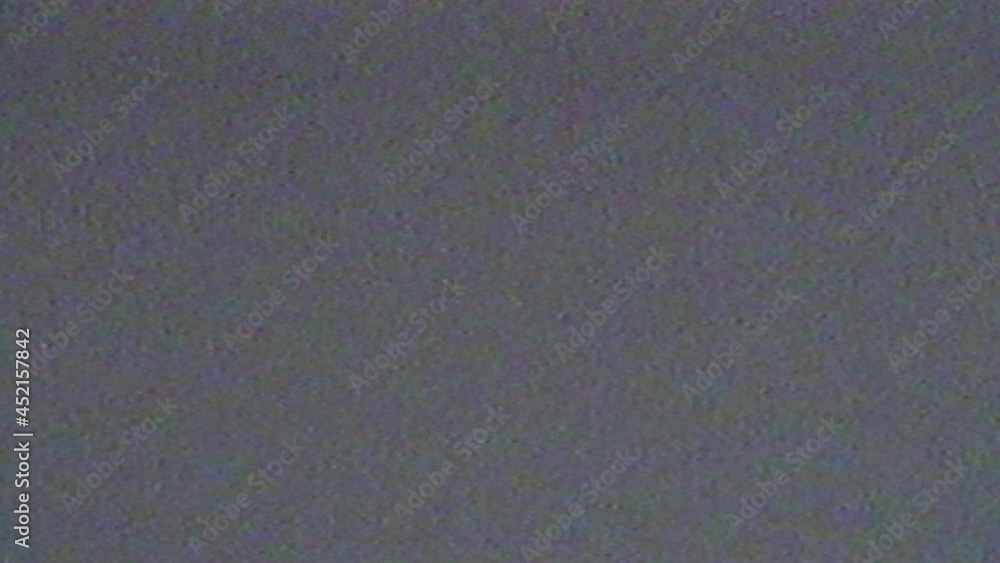 VHS shaking, flickering, defects, noise and artifacts on gray TV screen ...