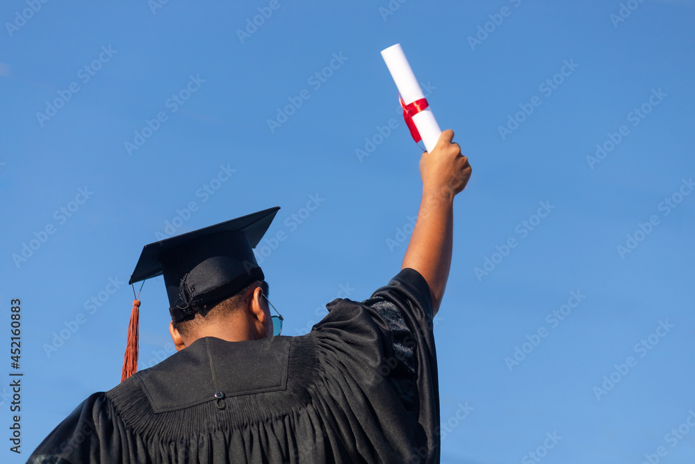The graduates raised their hands to celebrate graduation with a ...