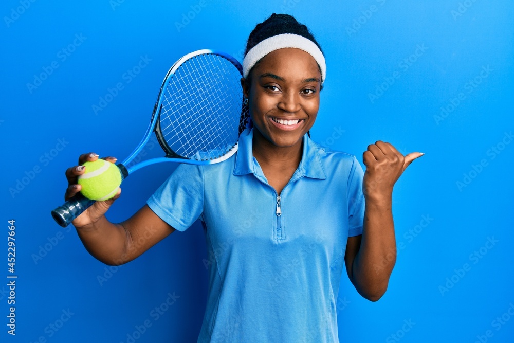 African american woman with braided hair playing tennis holding racket ...