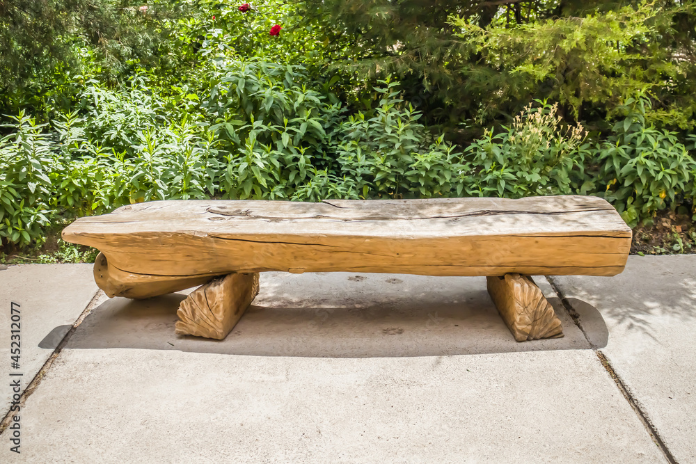 a rustic-style bench made of halved logs with log legs. most often ...
