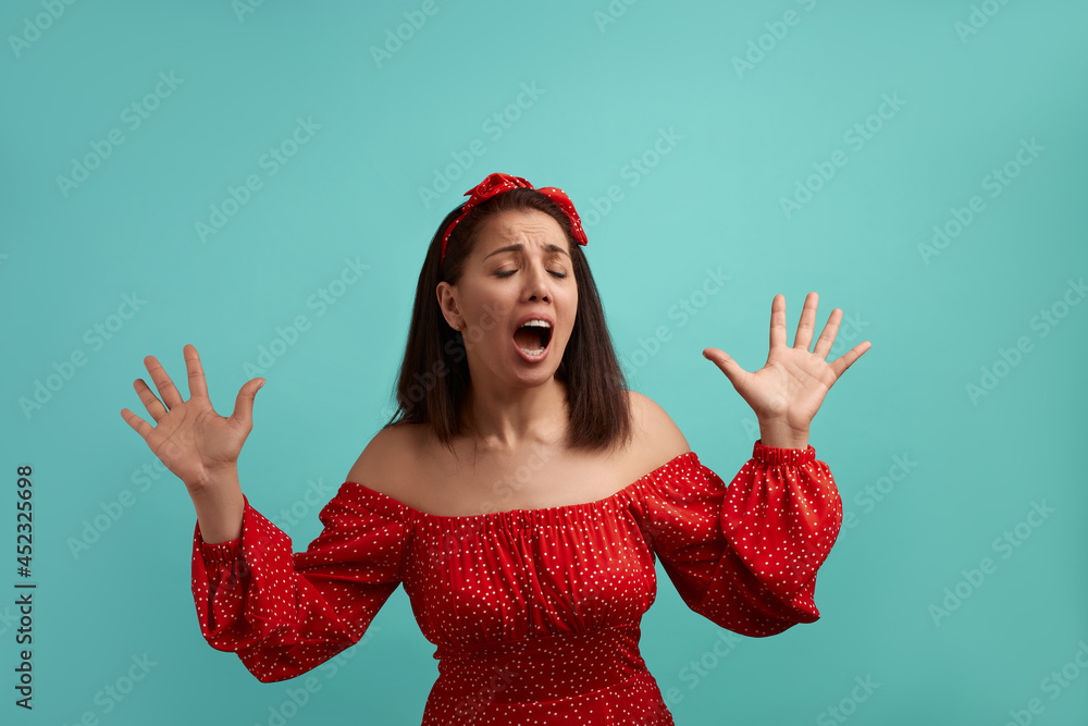 Desperate european woman, brunette in red dress with bare shoulders ...
