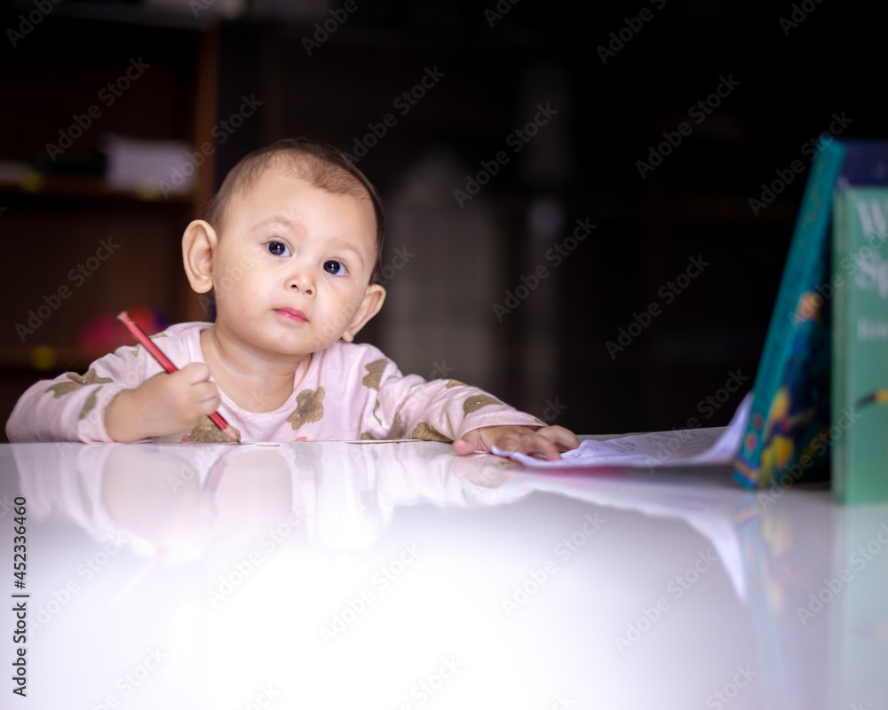 Baby Asian Girl drawing and playing as she develops her motor skills ...