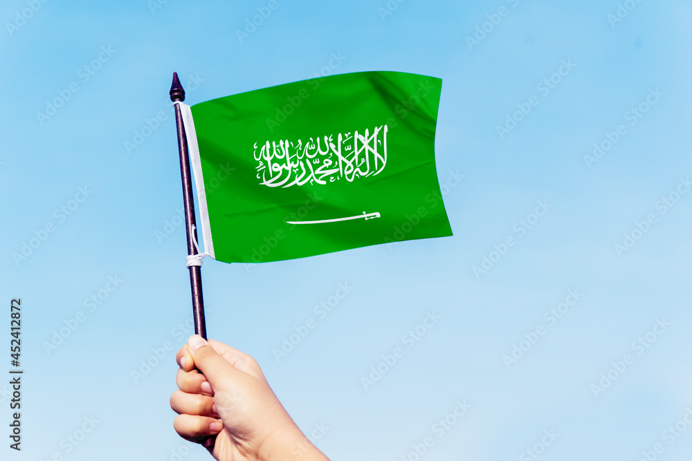 Little girl hands waving Saudi Arabia flag Stock Photo | Adobe Stock