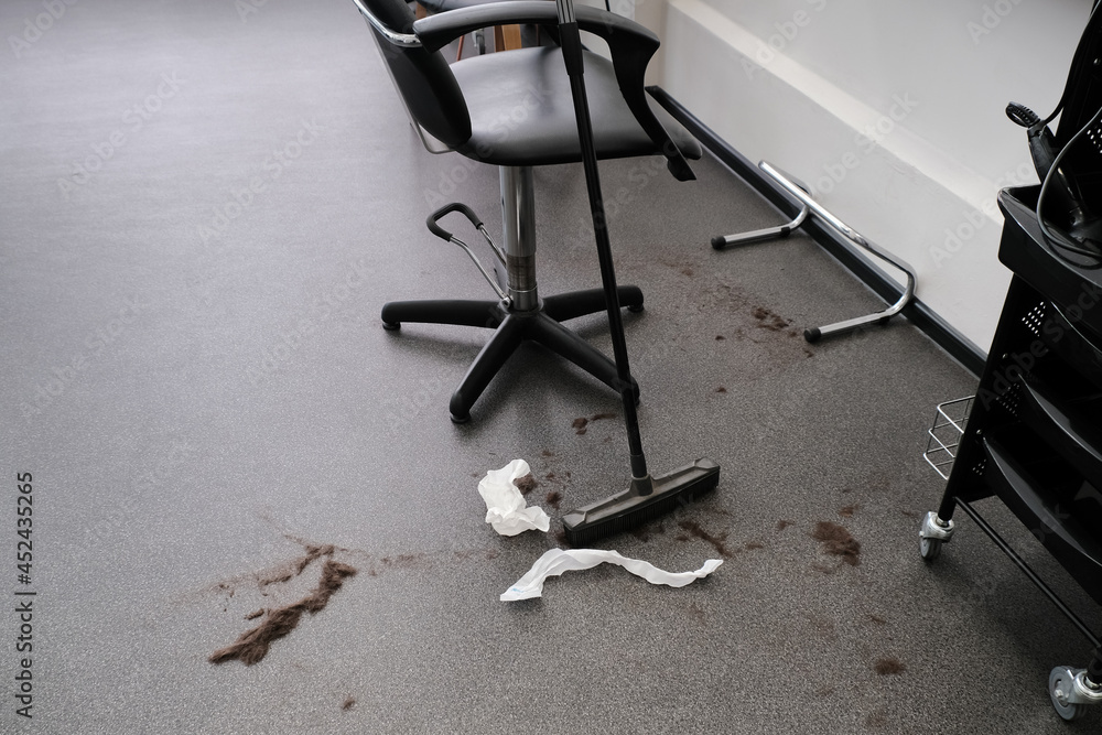 Hair on the floor after cutting hair in a barber shop. Hairdressers ...