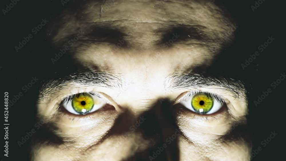 Unusual green eyes of a human expressing fear, surprise. Ominous ...
