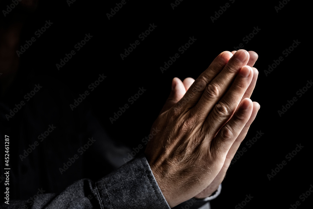 Praying hands on dark background Stock Photo | Adobe Stock