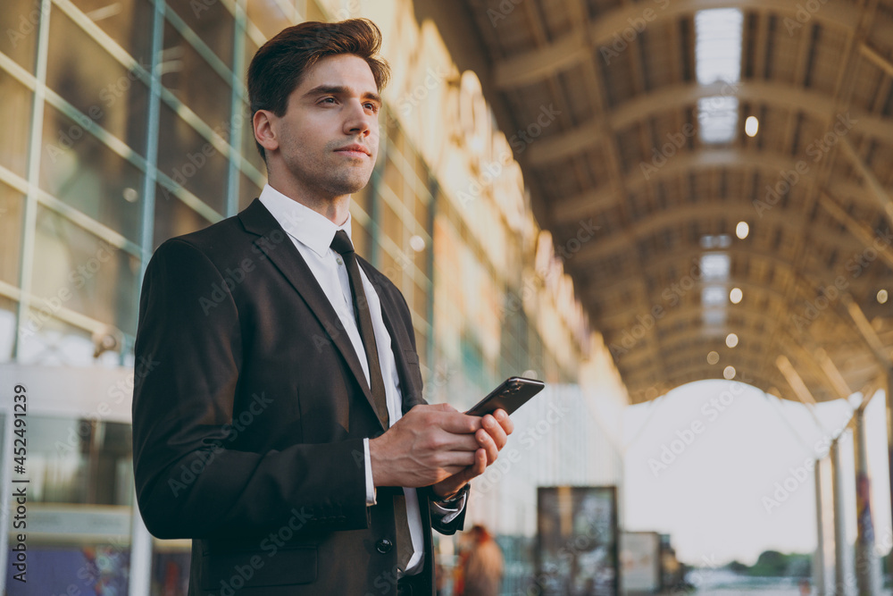 Bottom view traveler young minded businessman man 20s wear black dinner ...