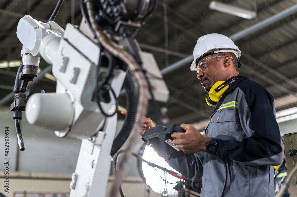 Robotics control engineers solve problems and setting programming of ...