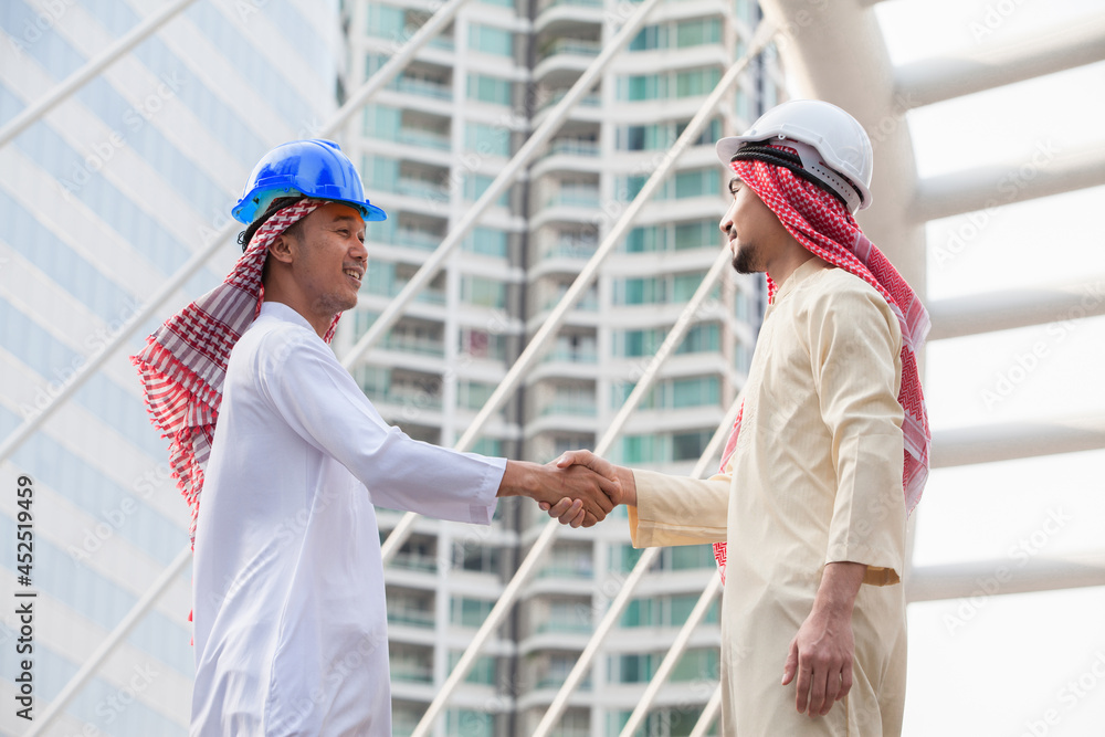 Handsome Arabian man shaking hands together after deal a business. Team ...