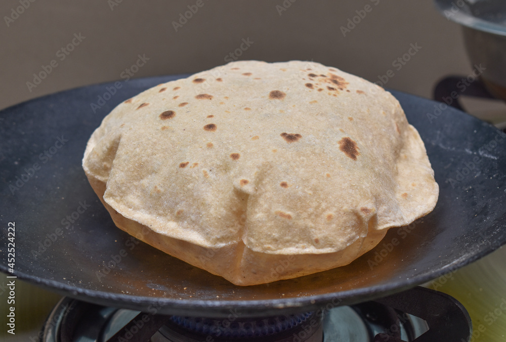 Poster Phulka Chapati (roti) on non stick tawa.Indian Subcontinent food ...