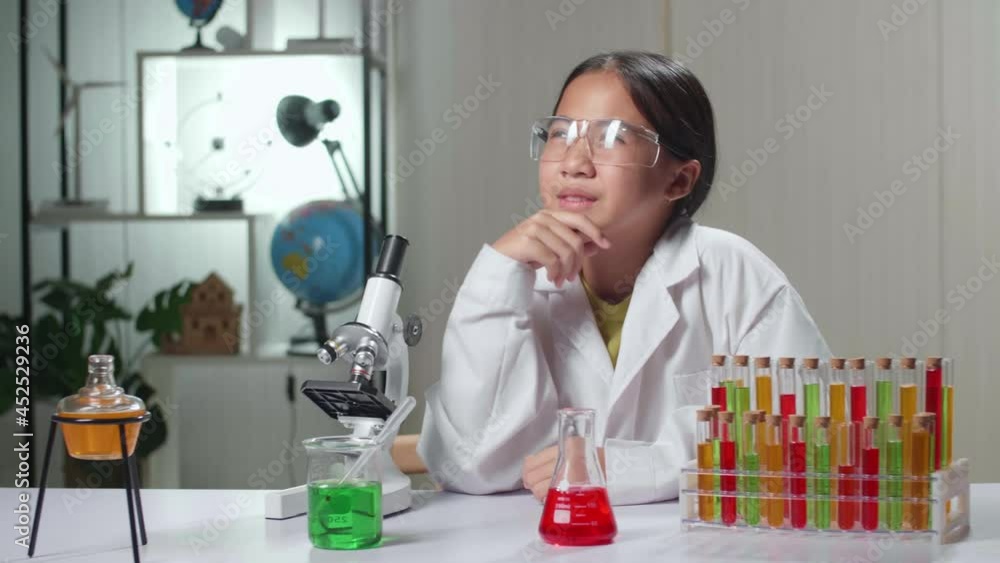 Young Scientist Girl Looking At Microscope And Thinking In Laboratory ...