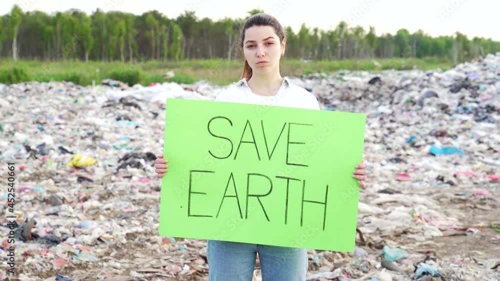 Video Stock portrait young woman activist with a poster in hands save ...