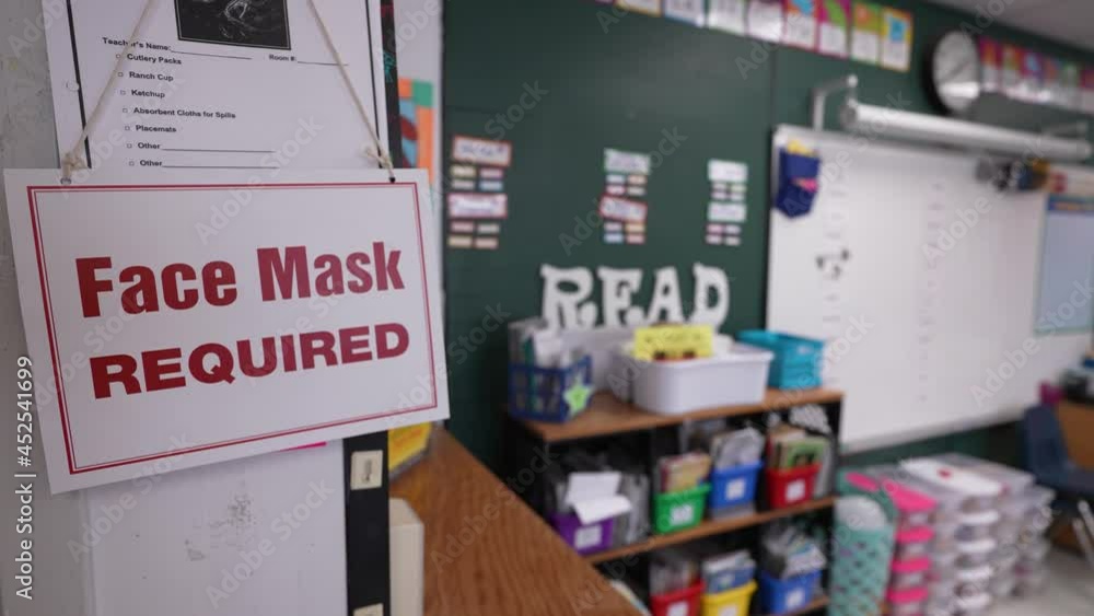 Face Mask Required sign in empty school classroom during pandemic ...