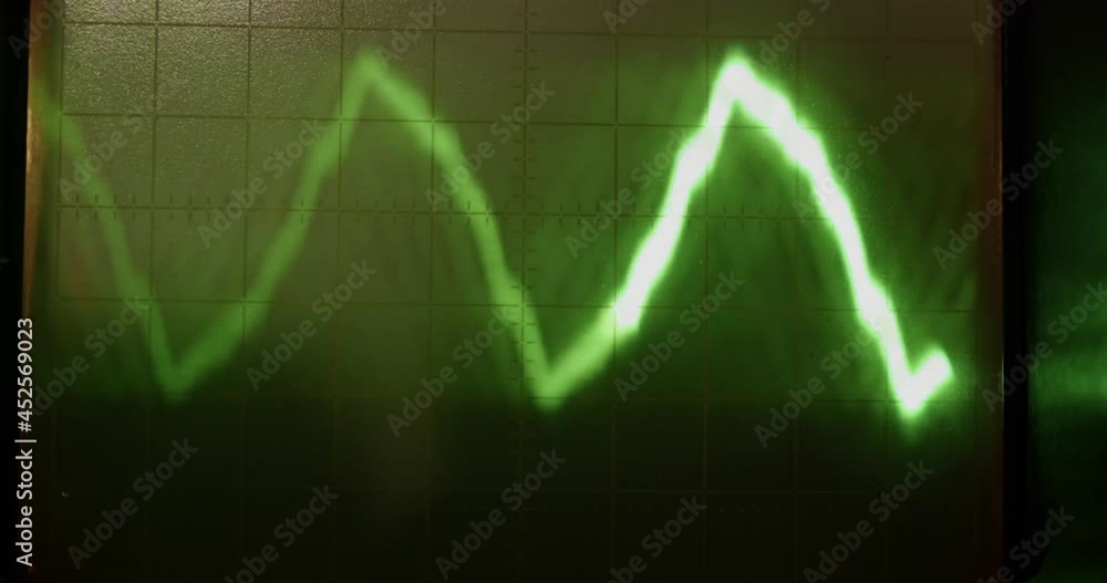 an oscilloscope screen with a green moving diagram. vintage retro ...