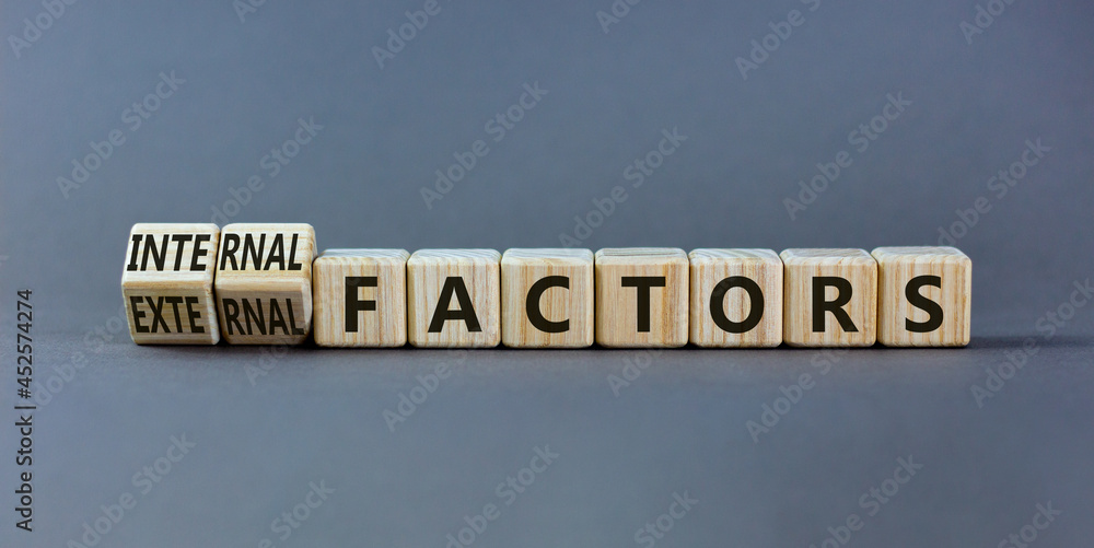 External or internal factors symbol. Turned wooden cubes and changed ...