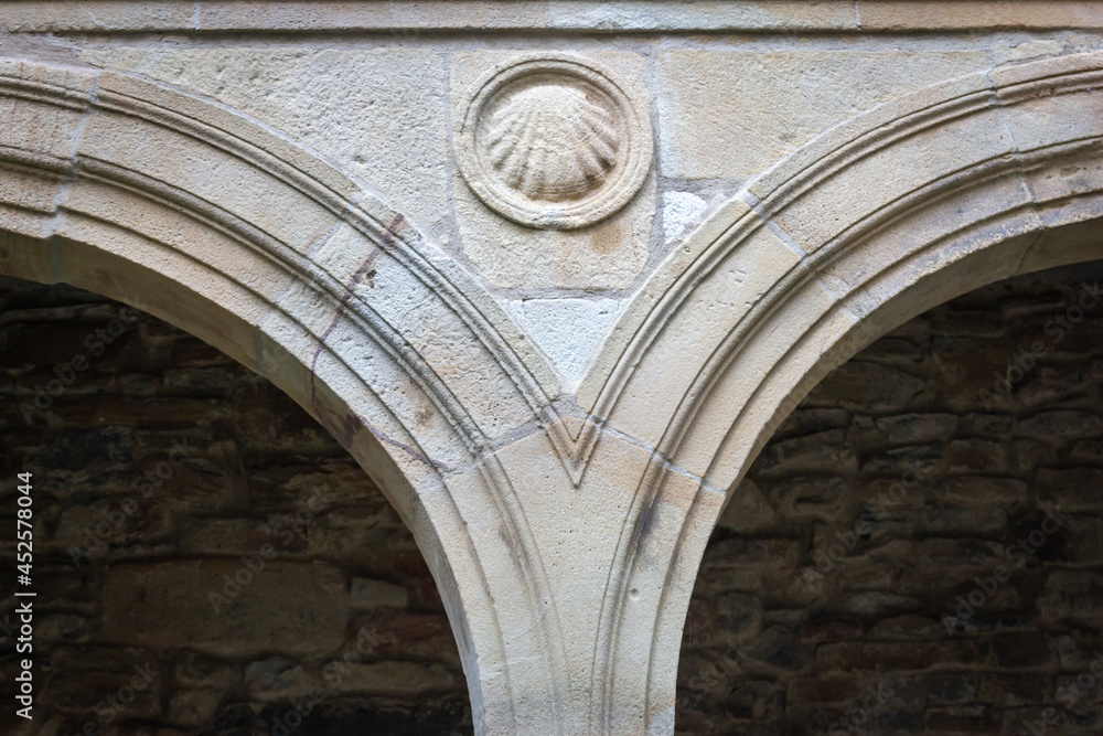 Shell on ancient catholic church. Pilgrimage symbol on cathedral wall ...