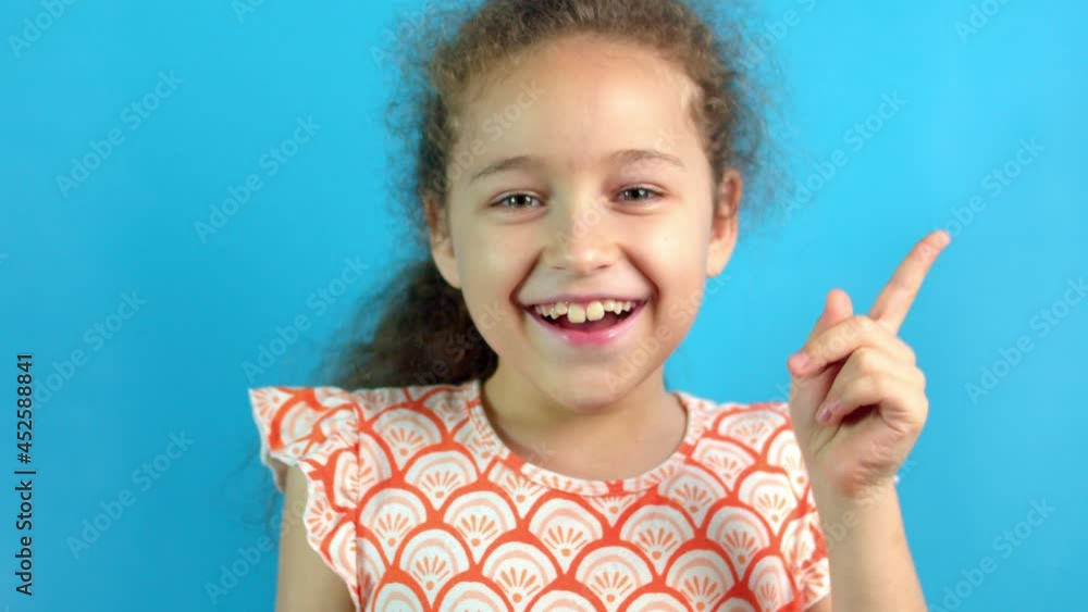 Smiling happy little girl showing eureka gesture. Portrait of young ...