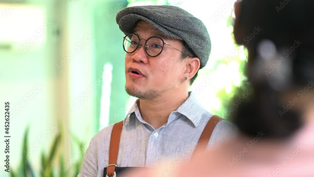 Video Stock 4K Asian male coffee shop manager briefing man and woman ...