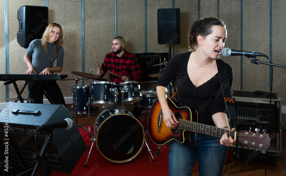 happy excited girl rock singer with guitar during rehearsal with male ...