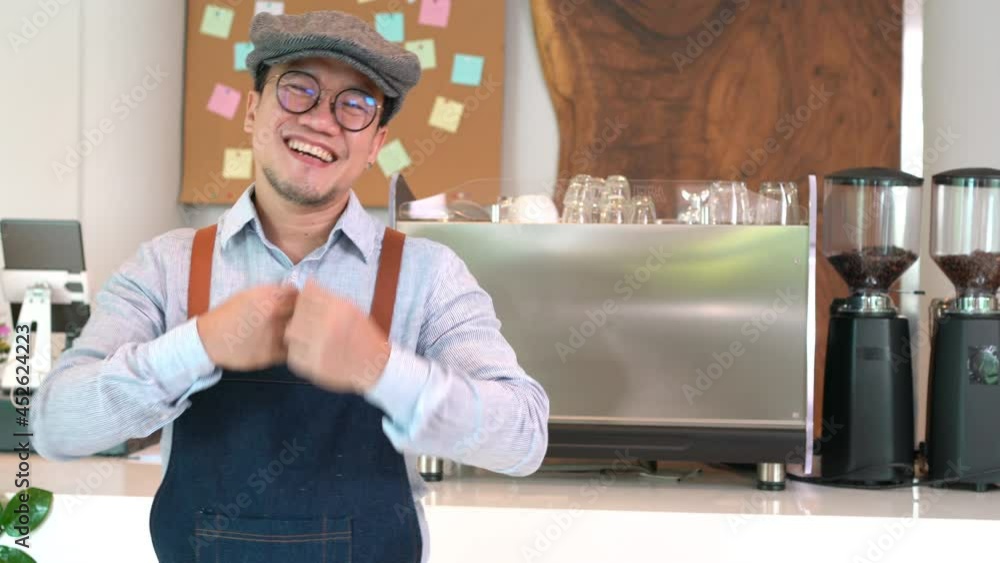 Portrait of Asian man coffee shop manager standing in front of bar ...