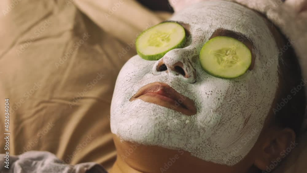 Face focusing of medium aged asian woman who is masking face with mud ...