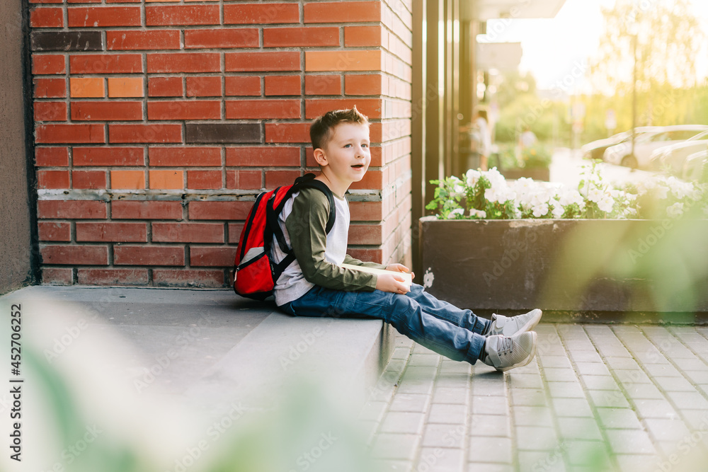 Back to school. Cute child with backpack, holding notepad and training ...