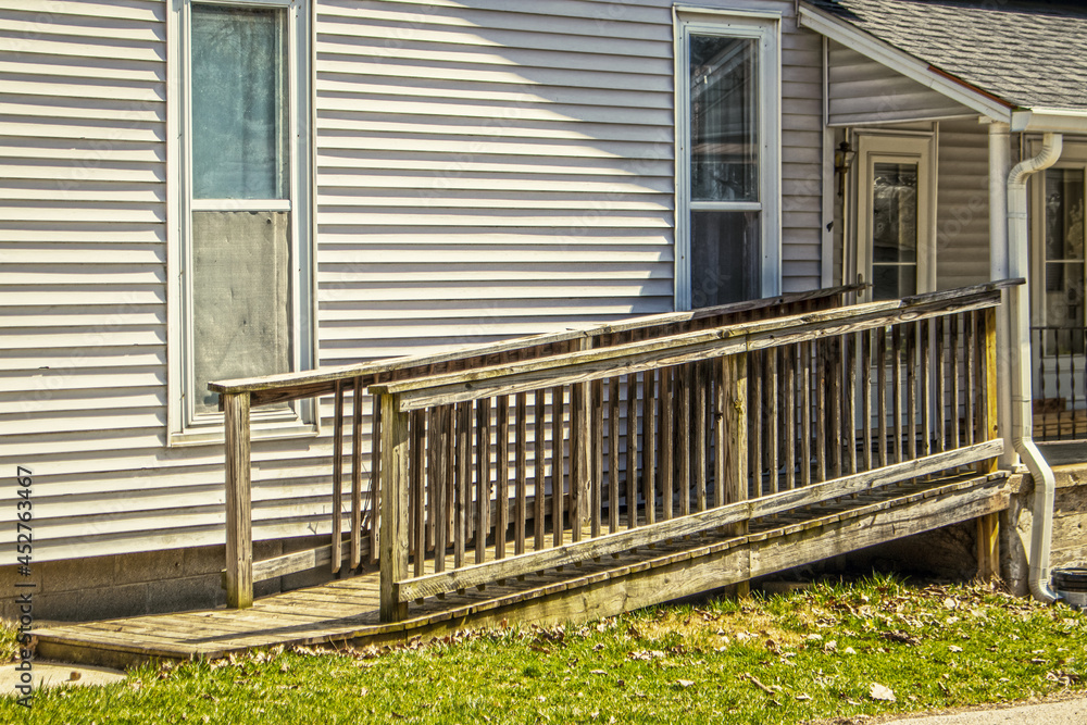 Rustic wooden handicap ramp on vintage house with fabric tacked up ...