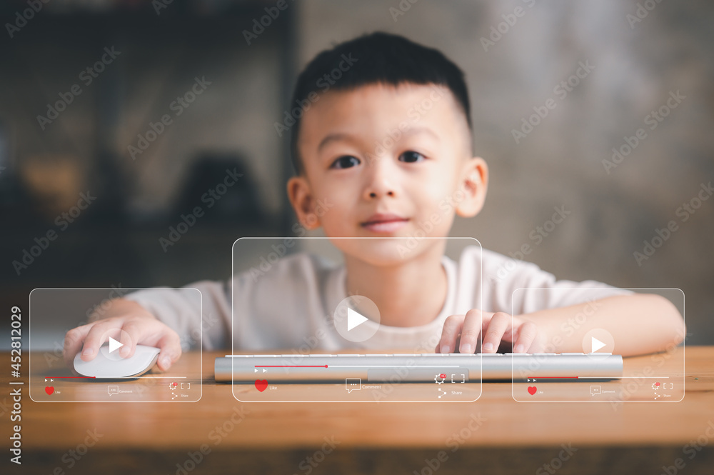 Asian boy using mouse and keyboard for streaming online, watching video ...