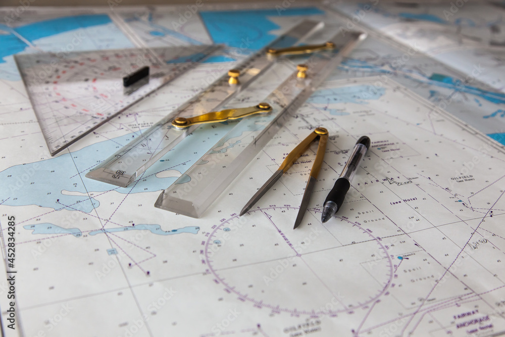 Maps of the ship for plotting. Plotter, divider, ruler and pen. Close ...