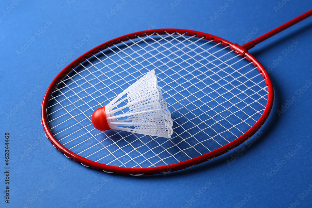 Badminton racket and shuttlecock on color background Stock Photo ...