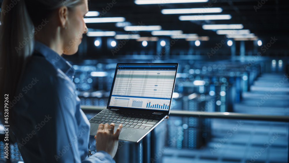 Data Center Female IT Specialist Uses Laptop Computer. Cloud Computing ...