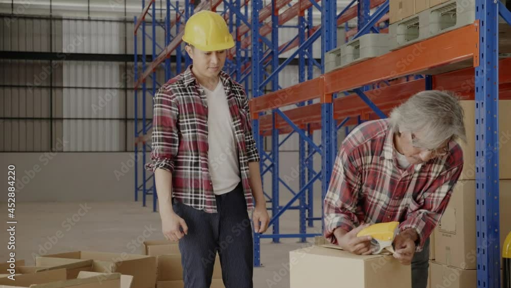 Group of workers are active packing boxes in warehouse for logistics ...