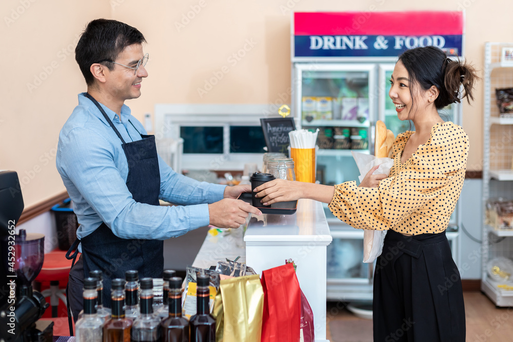 Business Owner. A cheerful successful small business owner standing to ...