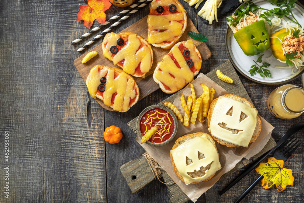 Halloween party food corner table scene over a wood background ...