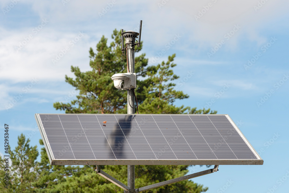 Solar powered surveillance camera. Solar panels powering a surveillance ...