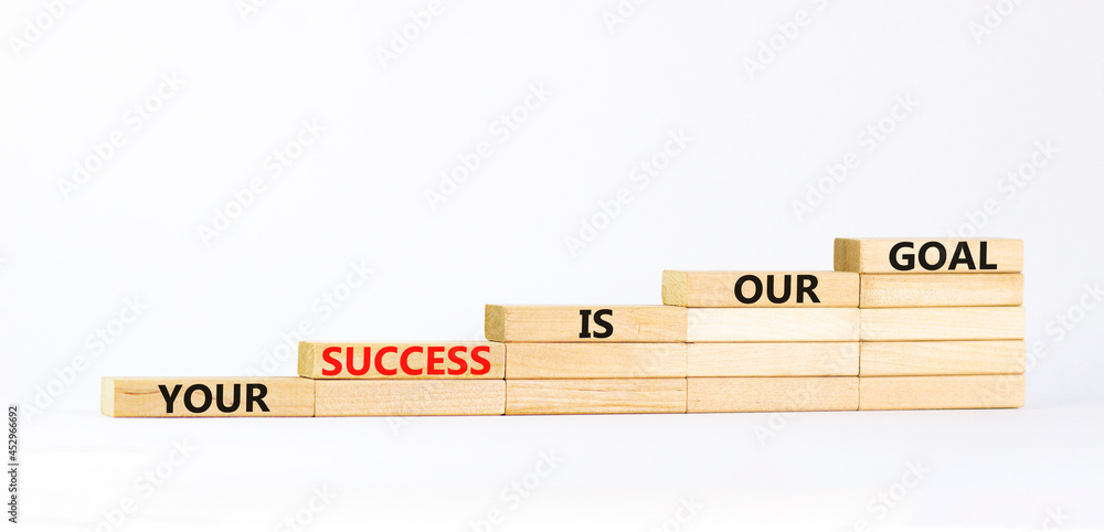 Your success business symbol. Wooden blocks with words 'your success is ...