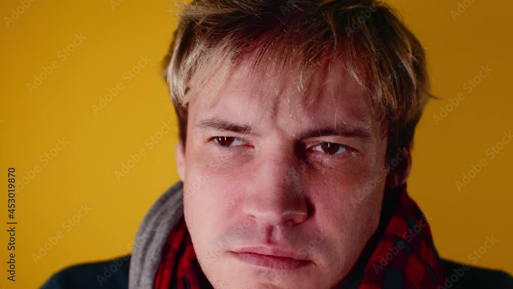 The man has a runny nose. A young guy in a scarf wipes his snot. A man ...
