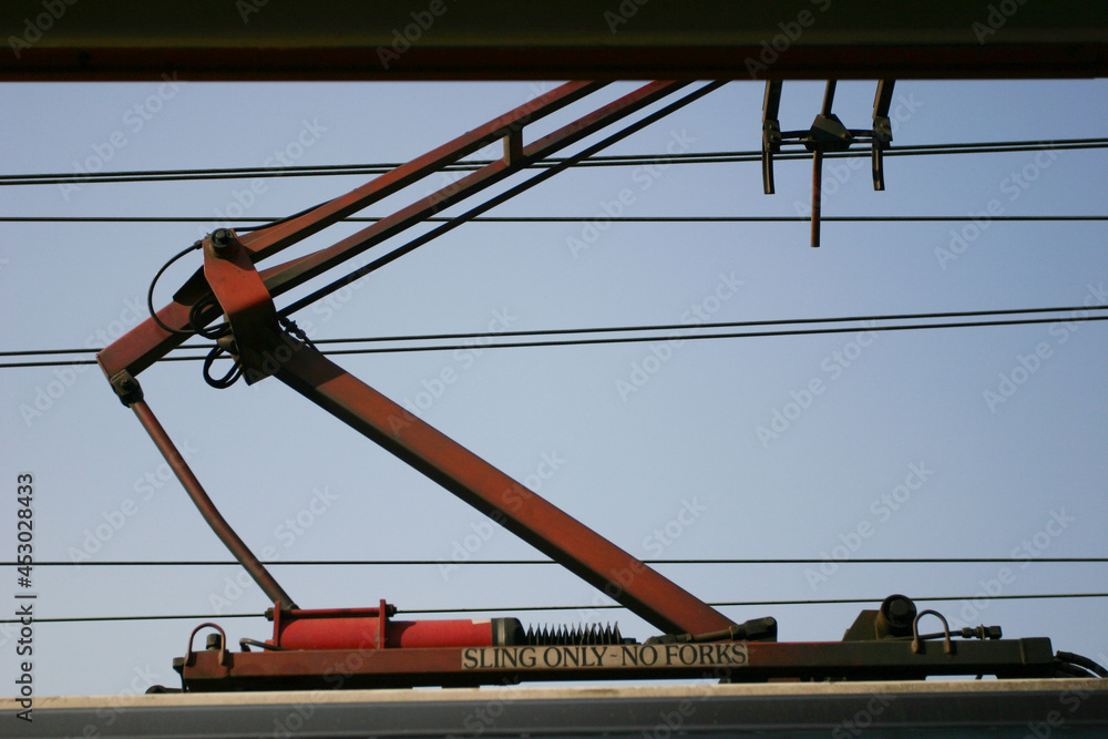 the asymmetrical pantograph connecting the train to the overhead ...