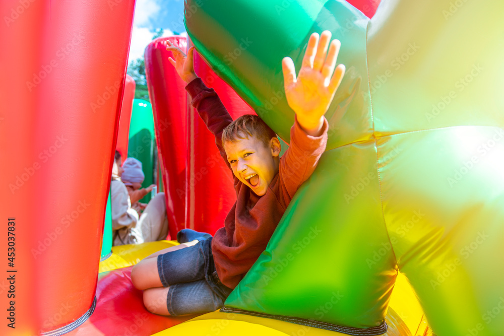 Child play on colorful playground trampoline. Kids jump in inflatable ...