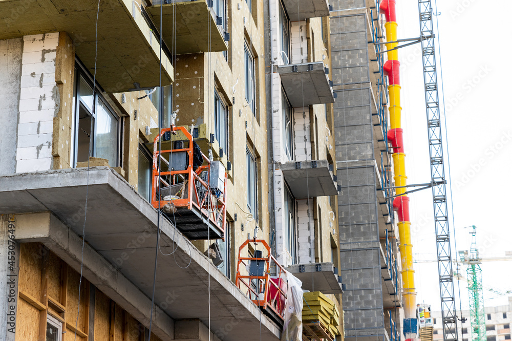 Suspended construction craddle near wall of hightower residentaial ...