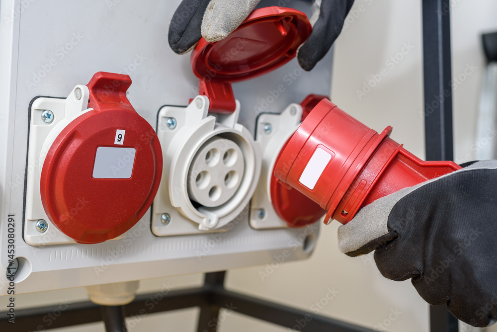Industrial sockets and plug on distribution board. Construction site ...