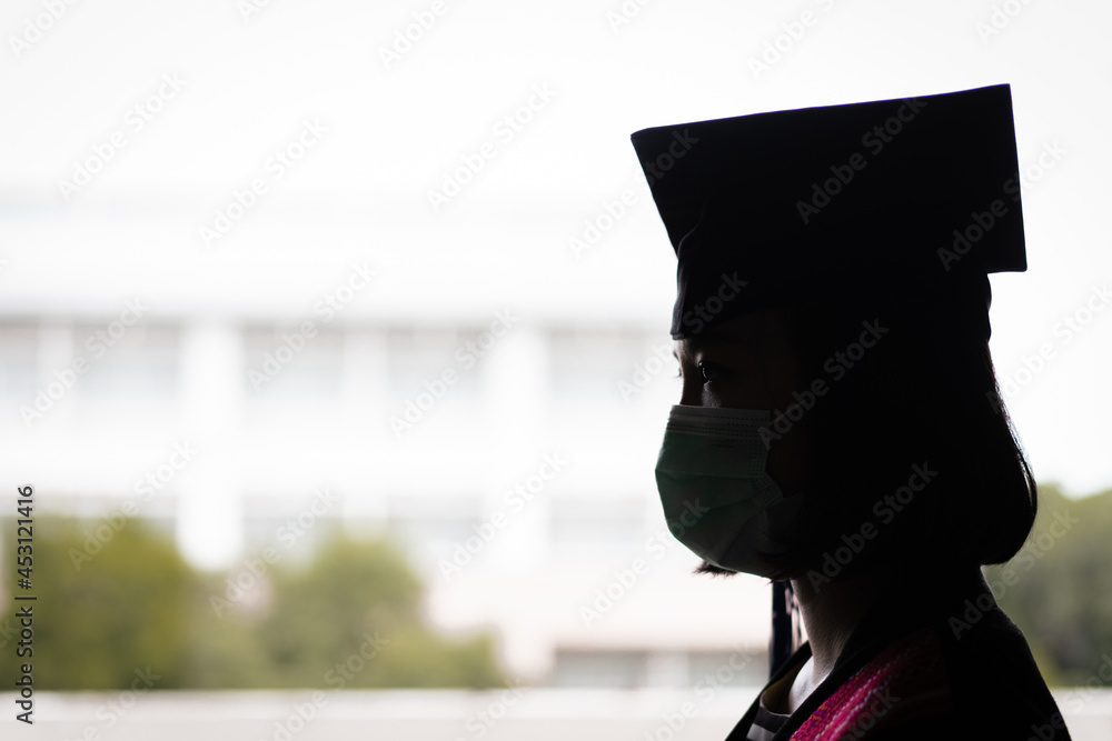 Silhouette photo of a young happy Asian woman university graduate in ...