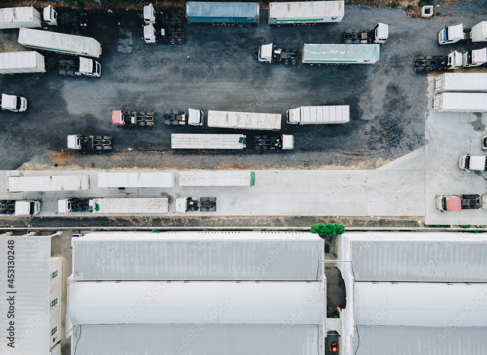 top view of the logistics with warehouse, loading hub, and many semi ...