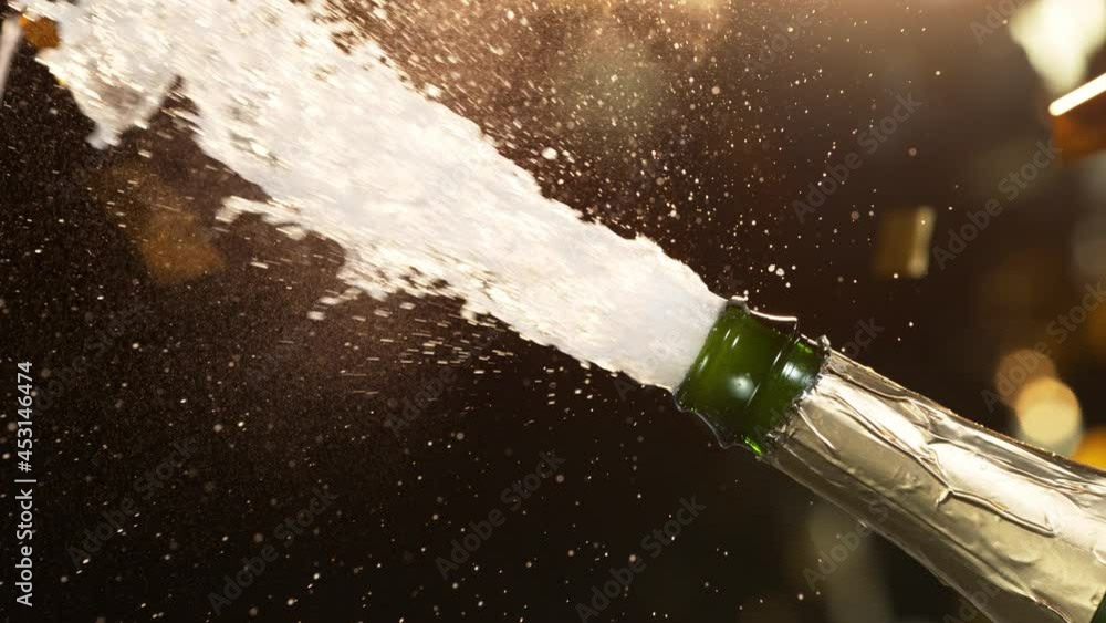 Super slow motion of Champagne explosion, opening champagne bottle closeup. Filmed on high speed ...