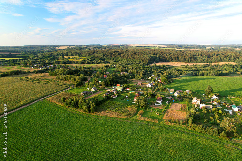 Top view of the village with wooden houses in wild among the forest and ...