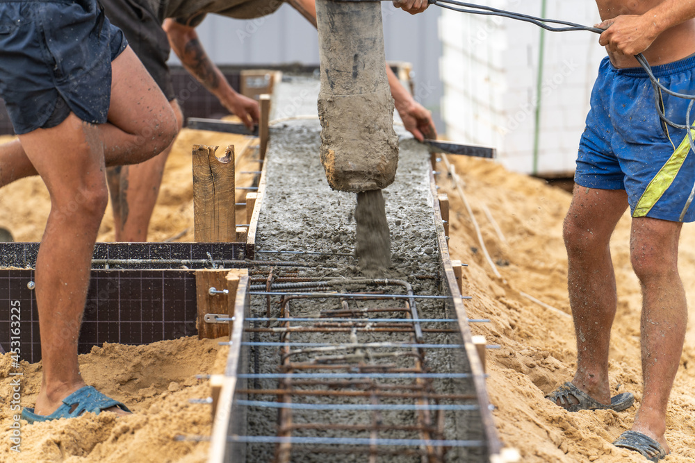 Pouring cement or concrete with automatic pump, construction site with ...